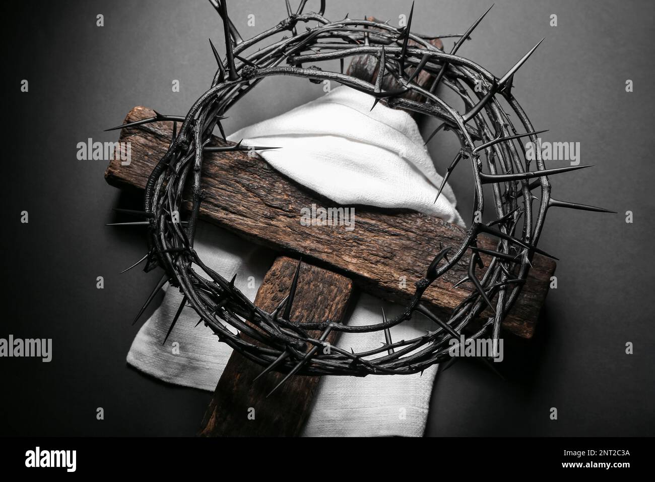 Crown of thorns, wooden cross and shroud on dark background Stock Photo ...