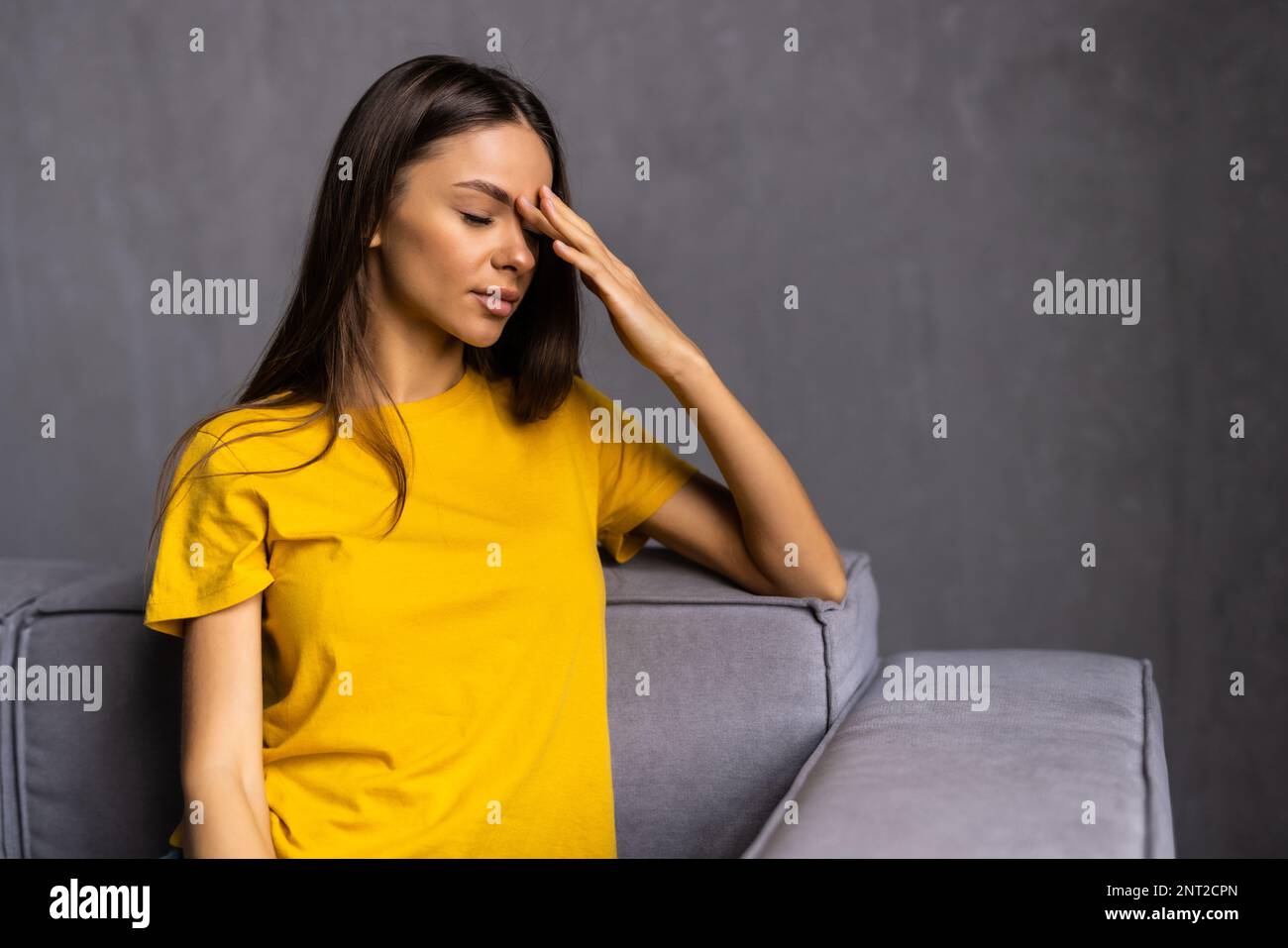 Depressed sad attractive woman crying on sofa couch at home feeling ...