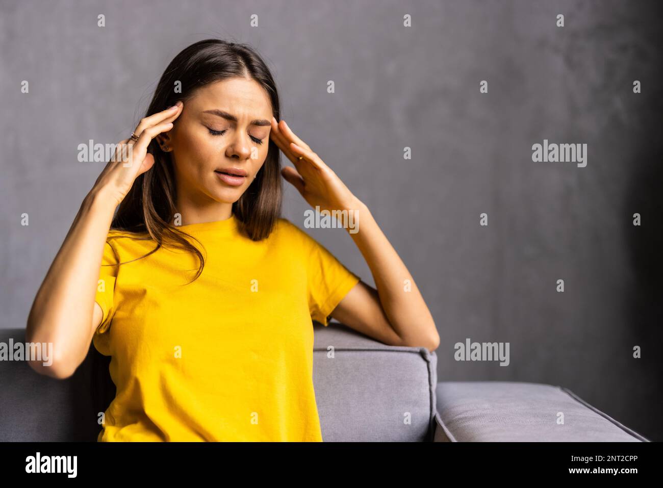 Depressed sad attractive woman crying on sofa couch at home feeling ...