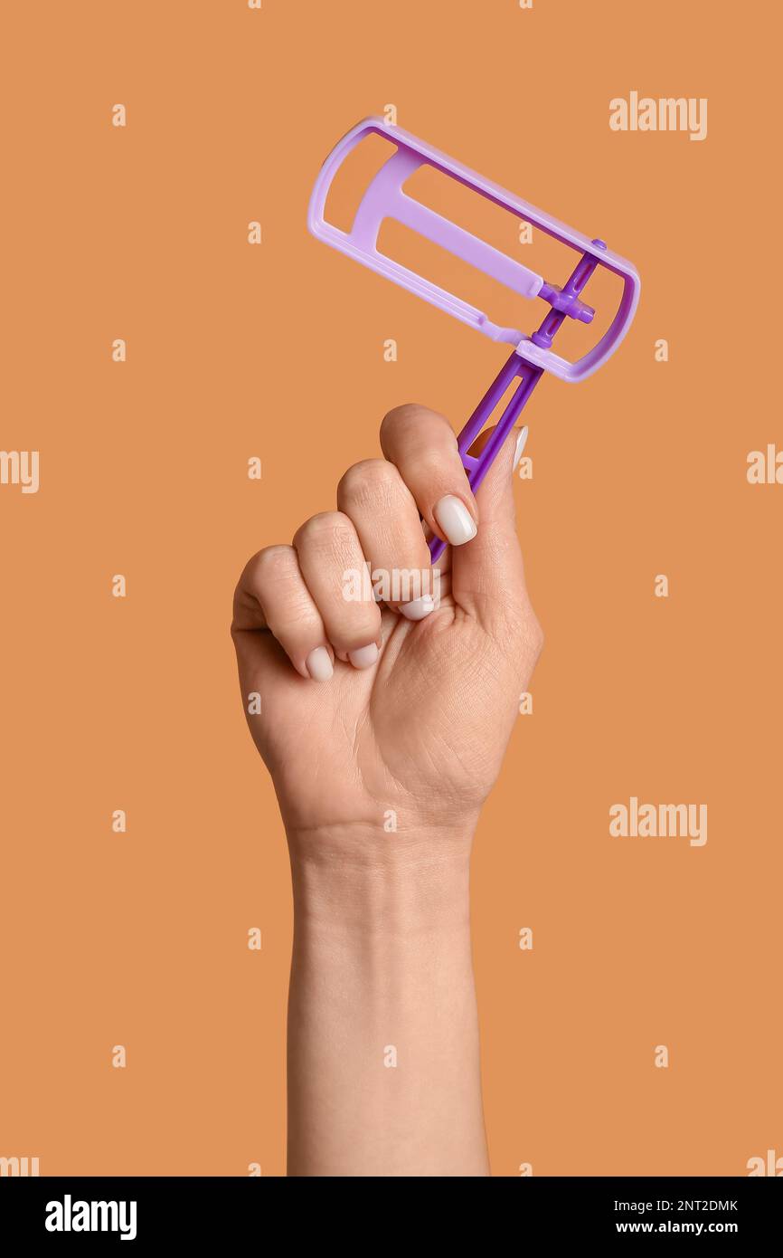 Woman with Jewish rattle for Purim holiday on color background Stock ...