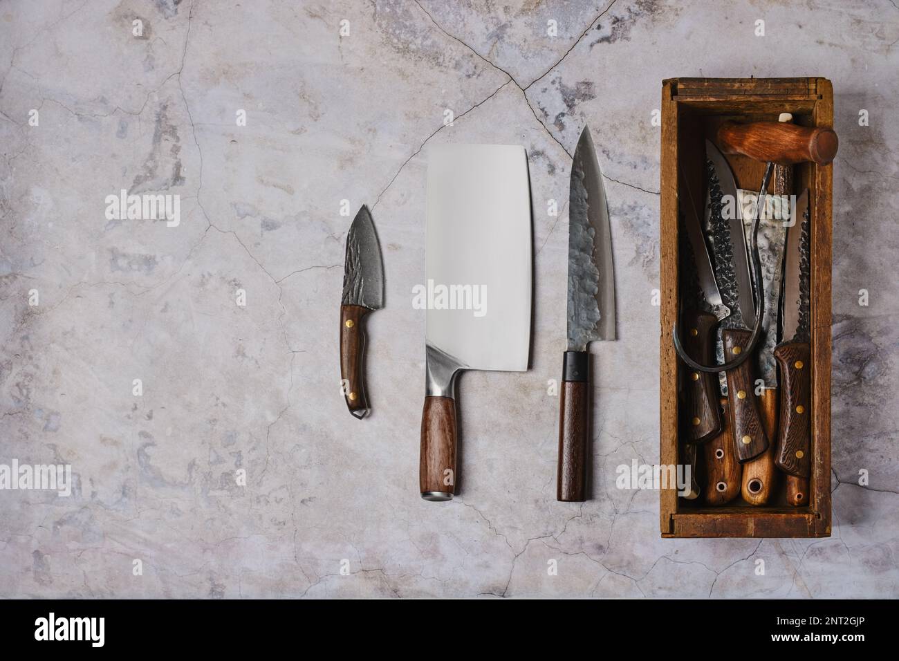 Used forged tools of butcher on stone background Stock Photo - Alamy
