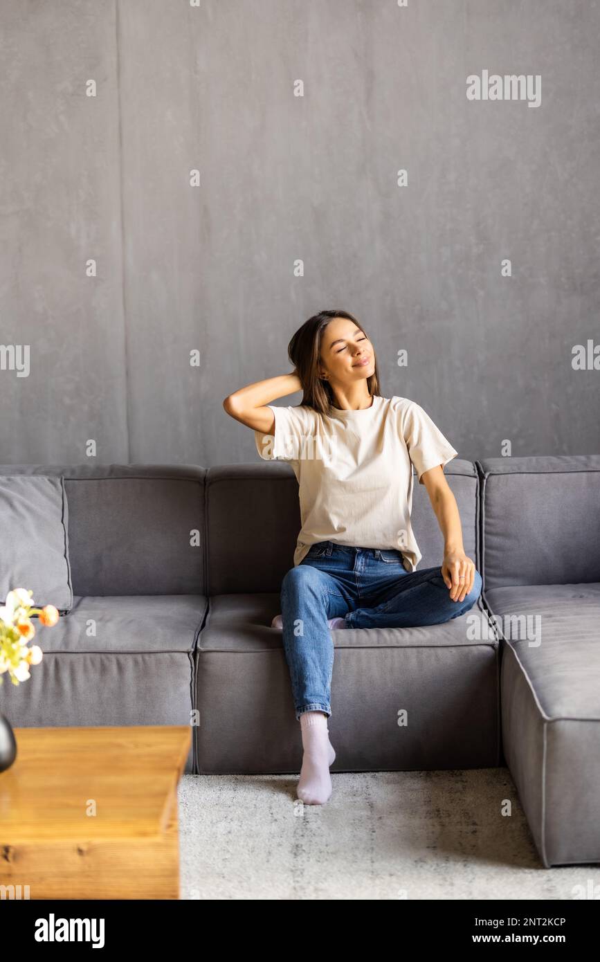 Relaxed serene pretty young woman feel fatigue lounge on comfortable ...