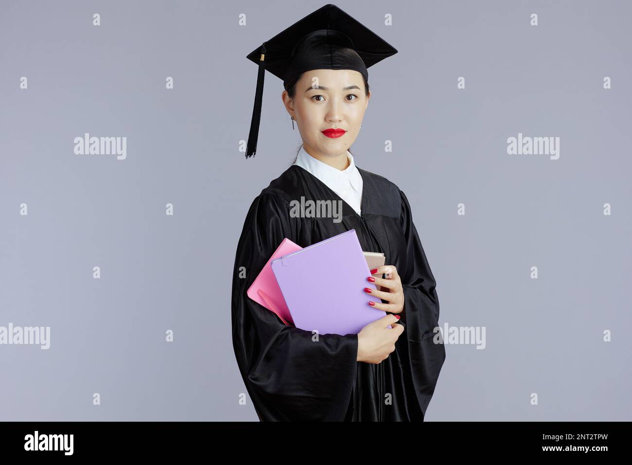 modern female asian graduate student with books and notebooks isolated ...