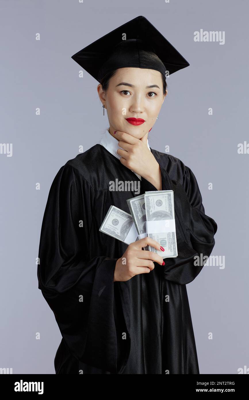 smiling modern female asian graduate student with money isolated on ...
