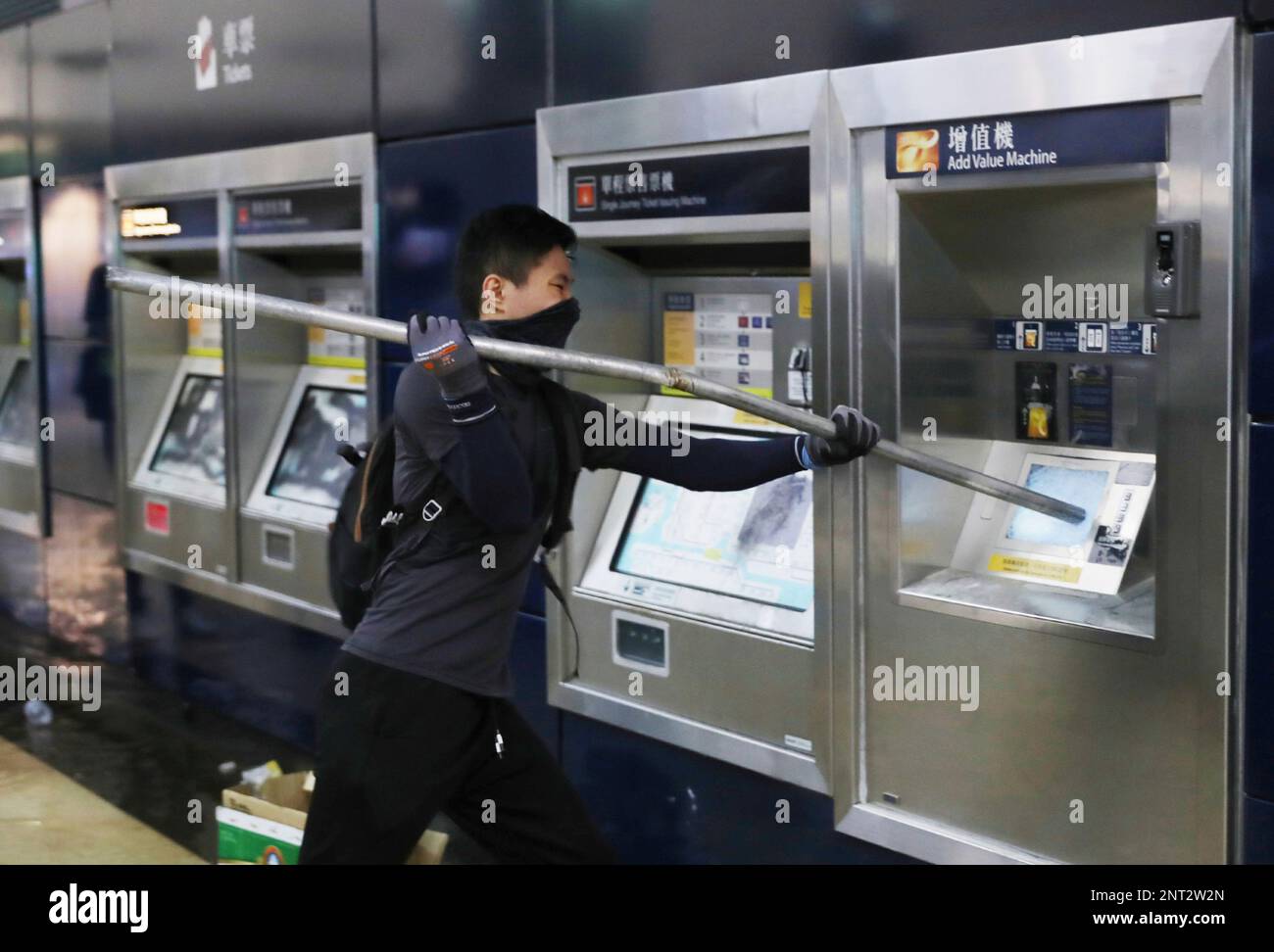 Protesters break the ticket vending machine at Tung Chung station, near ...