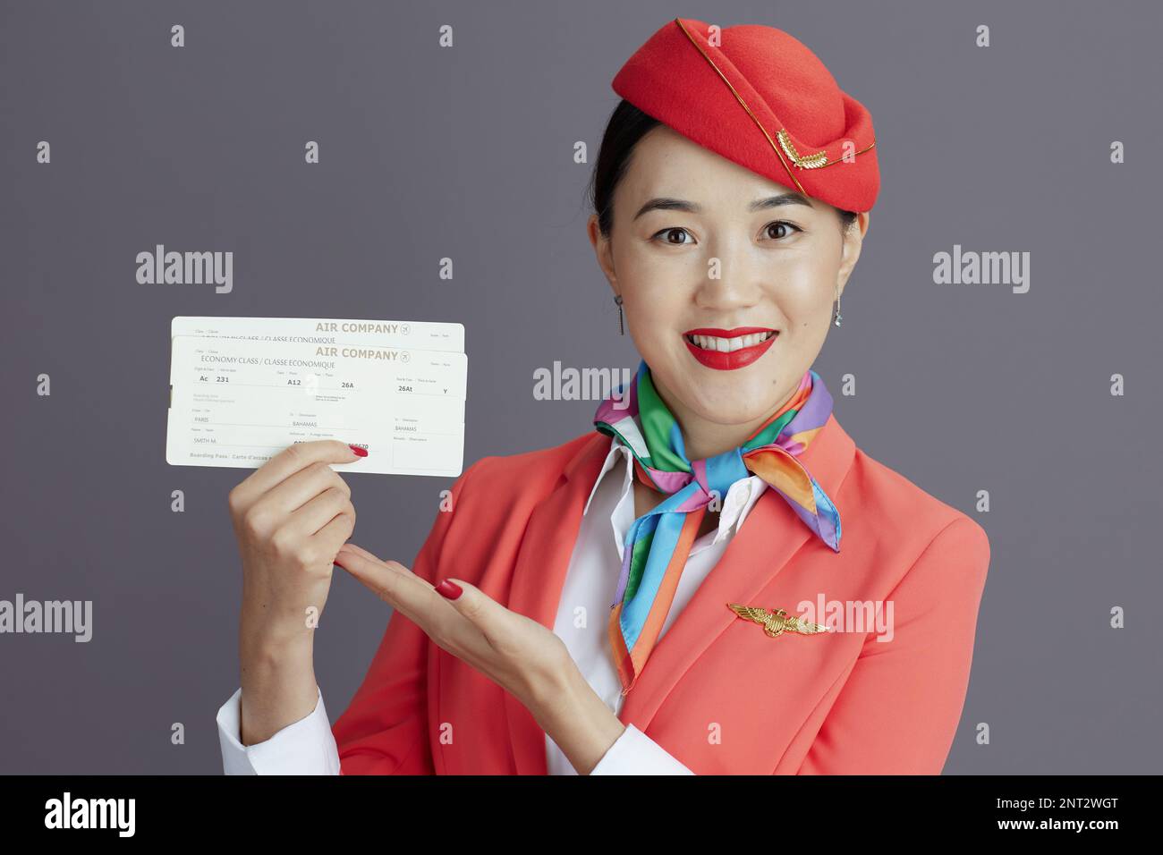 happy stylish air hostess asian woman in red skirt, jacket and hat ...