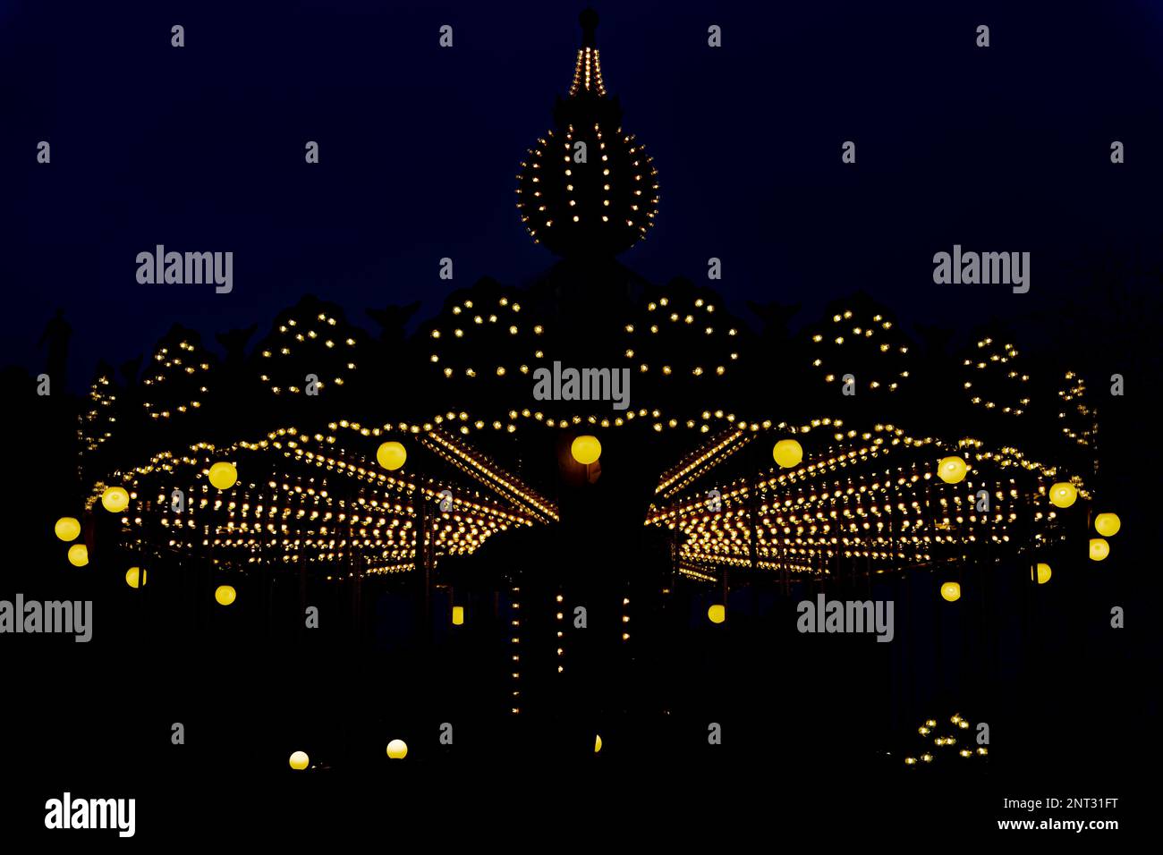 Night carousel illuminated with yellow lights Stock Photo - Alamy
