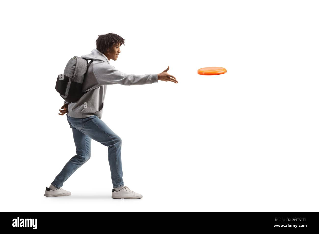 Full length profile shot of a young african american man throwing a ...
