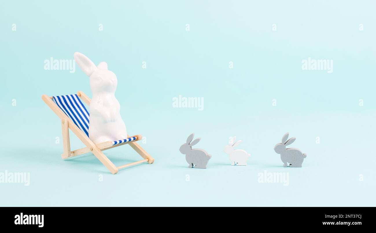 Bunny or rabbit sitting on lounge chair, kids next to mother, easter ...