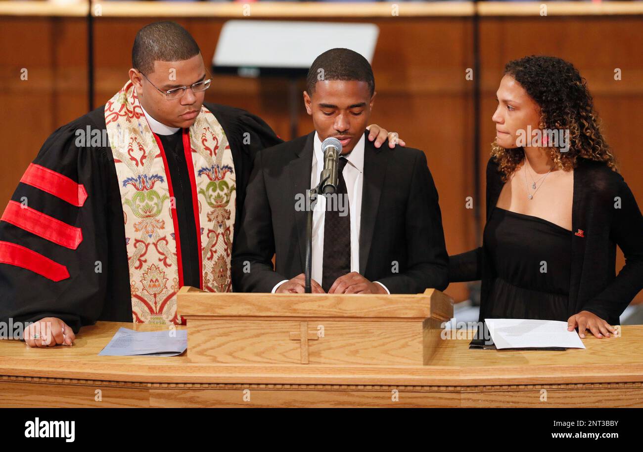Dr. Kevin Murriel (from left), senior pastor, comforts Derrick Lottie ...