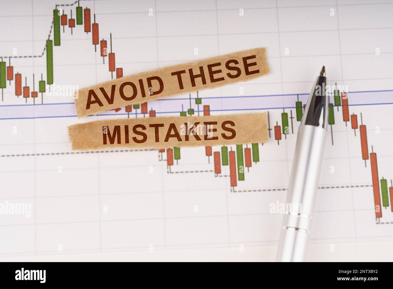 Business concept. On the chart of business quotes lies a pen and torn ...