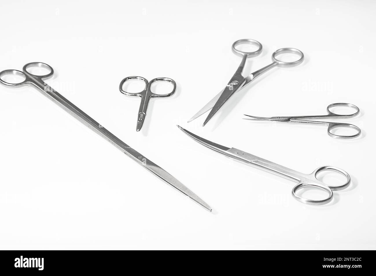 A set of various scissors for a hairdresser on a light background with ...