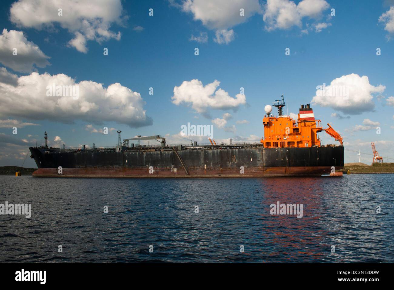 Moored 0il/chemical tanker with orange superstructure waiting for ...