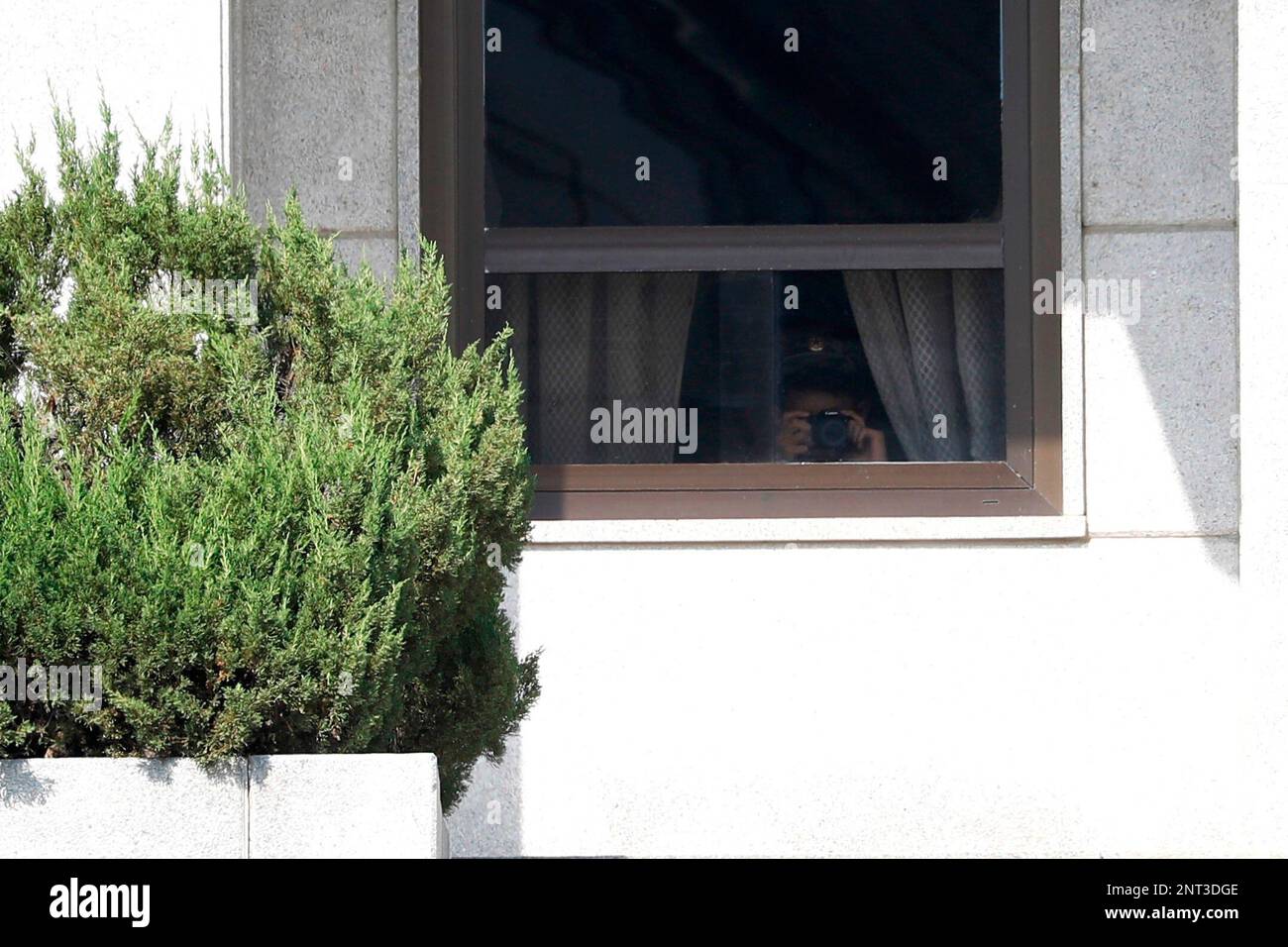 A North Korean soldier takes a picture as he looks toward the south at ...