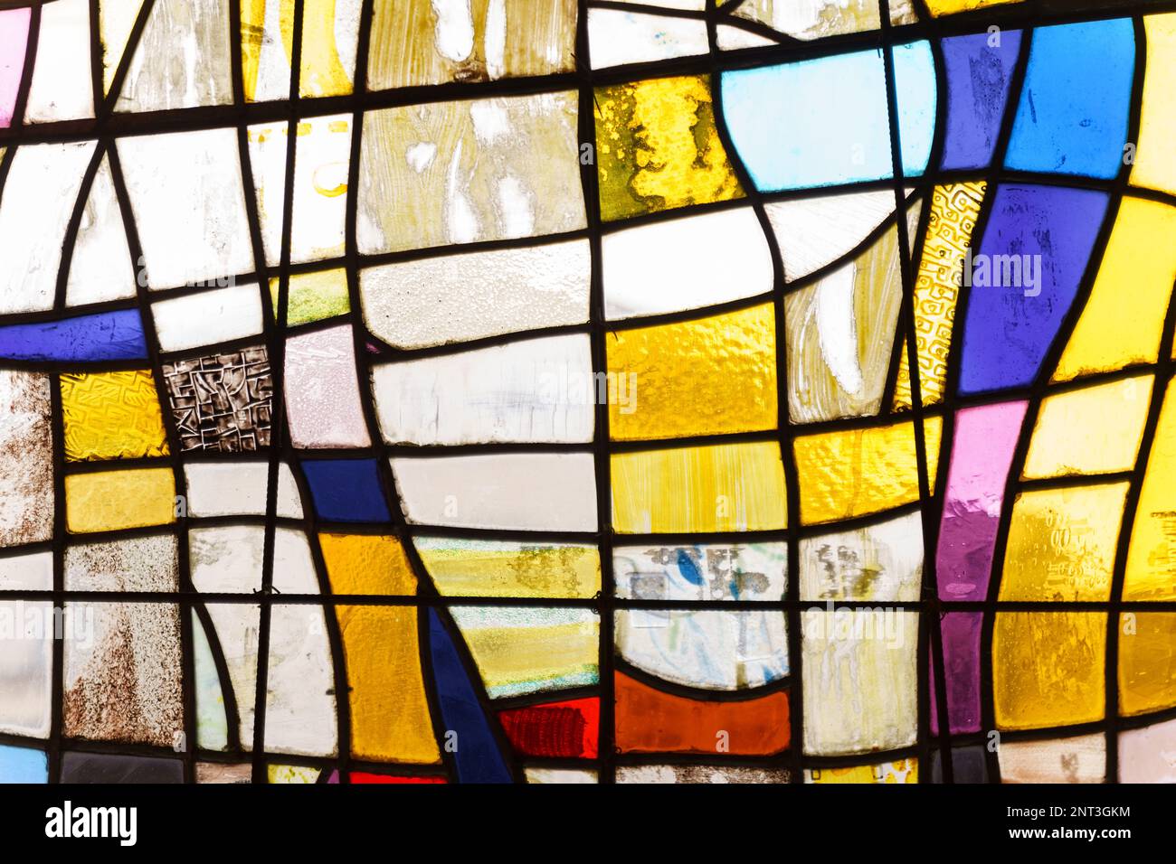 The texture of a glass stained glass window with shades of yellow, blue ...