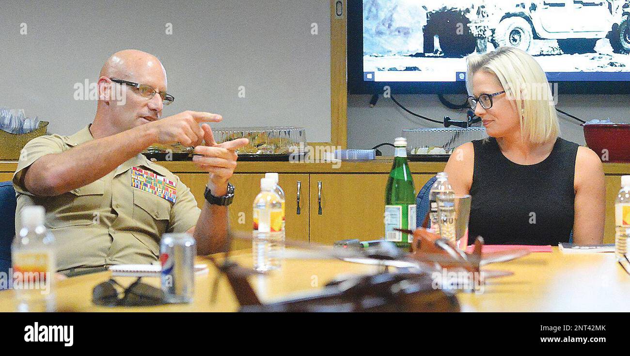 U.S. Sen. Kyrsten Sinema, D-Ariz., (right) listens as U.S. Marine Corps ...