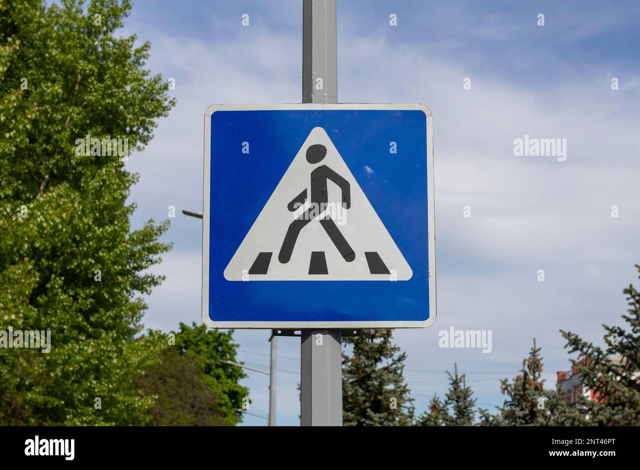 Blue and white pedestrian crossing sign Stock Photo - Alamy