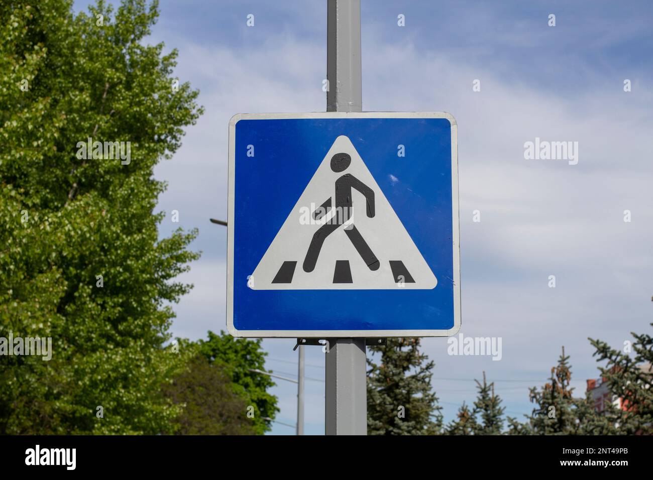 Blue and white pedestrian crossing sign Stock Photo - Alamy