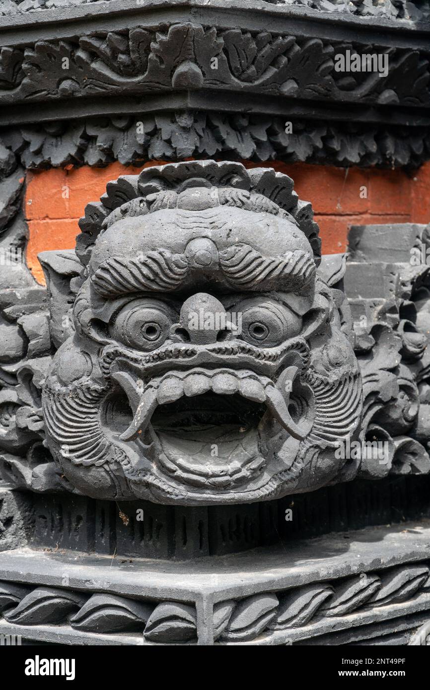 Black masks made of concrete at the temple's entrance in Nusa Dua, Bali ...
