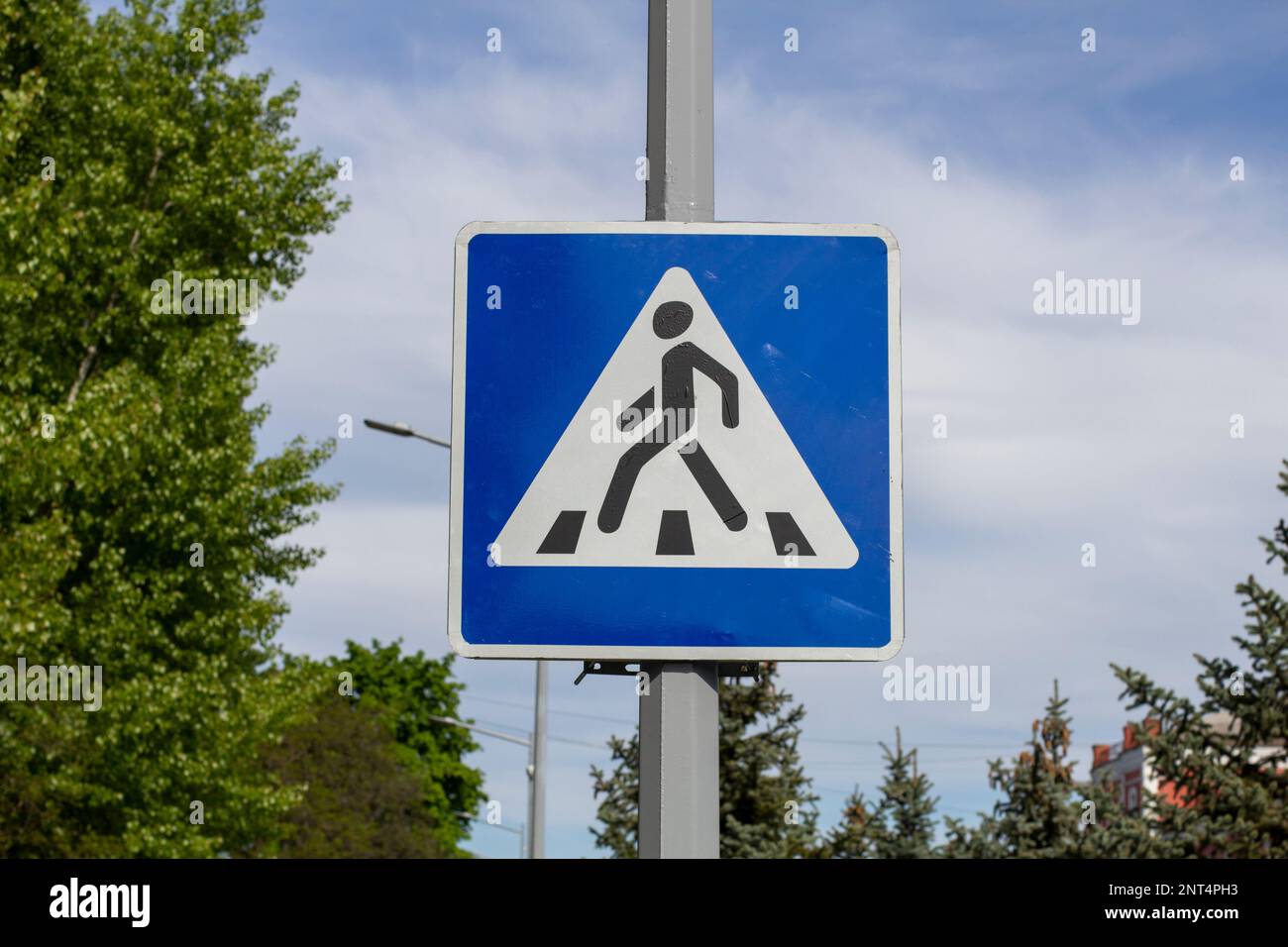 Blue and white pedestrian crossing sign Stock Photo - Alamy