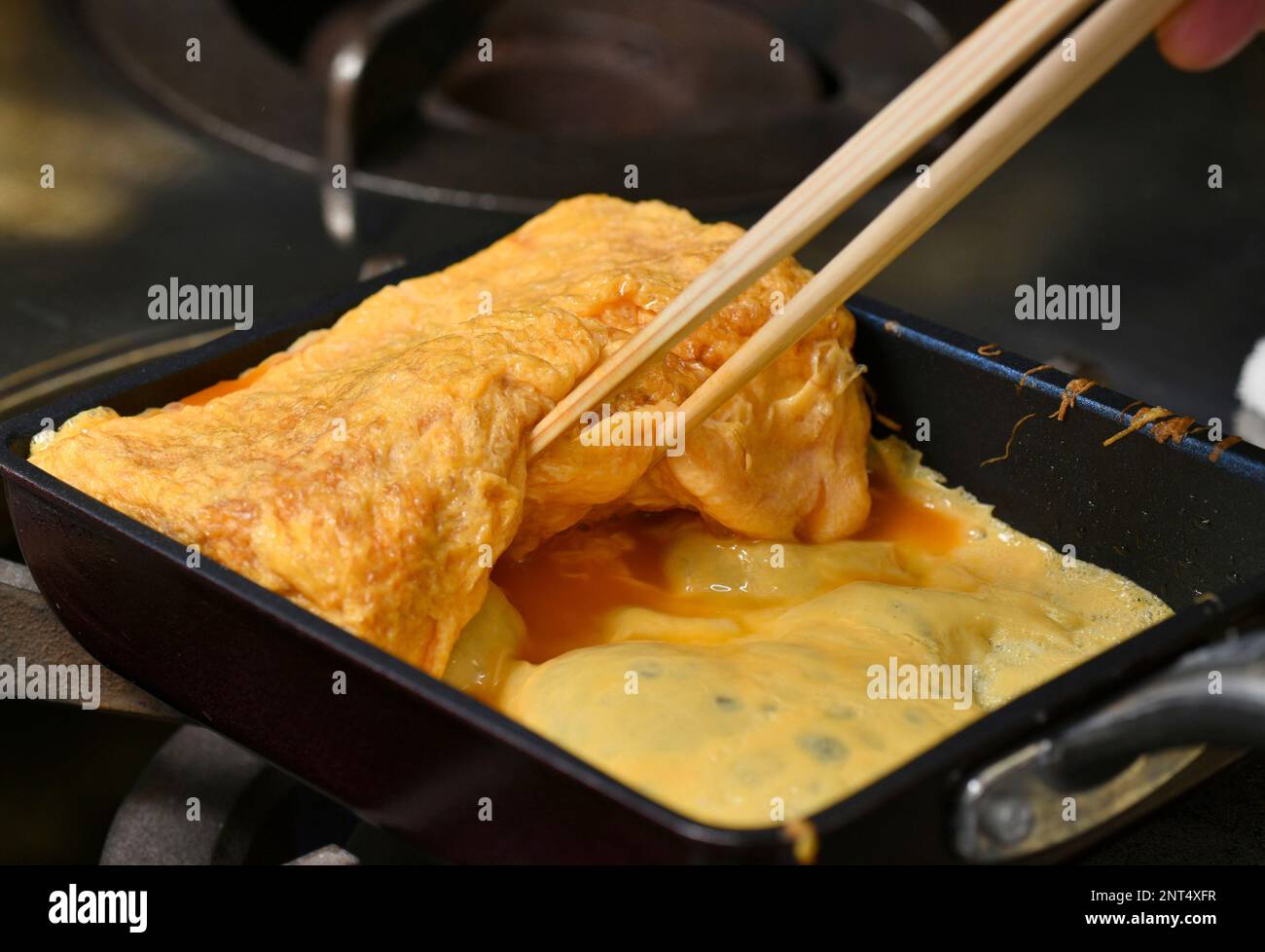 A picture shows the way to make Tamago-yaki, Japanese traditional ...