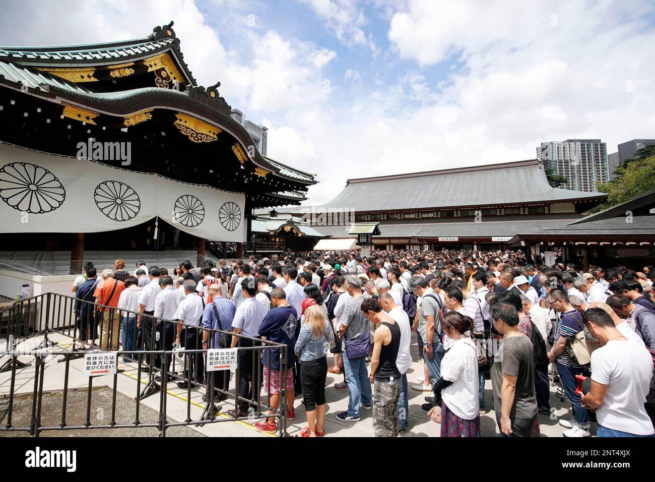 Visitors offer a moment of silence at Yasukuni shrine in Tokyo Thursday ...
