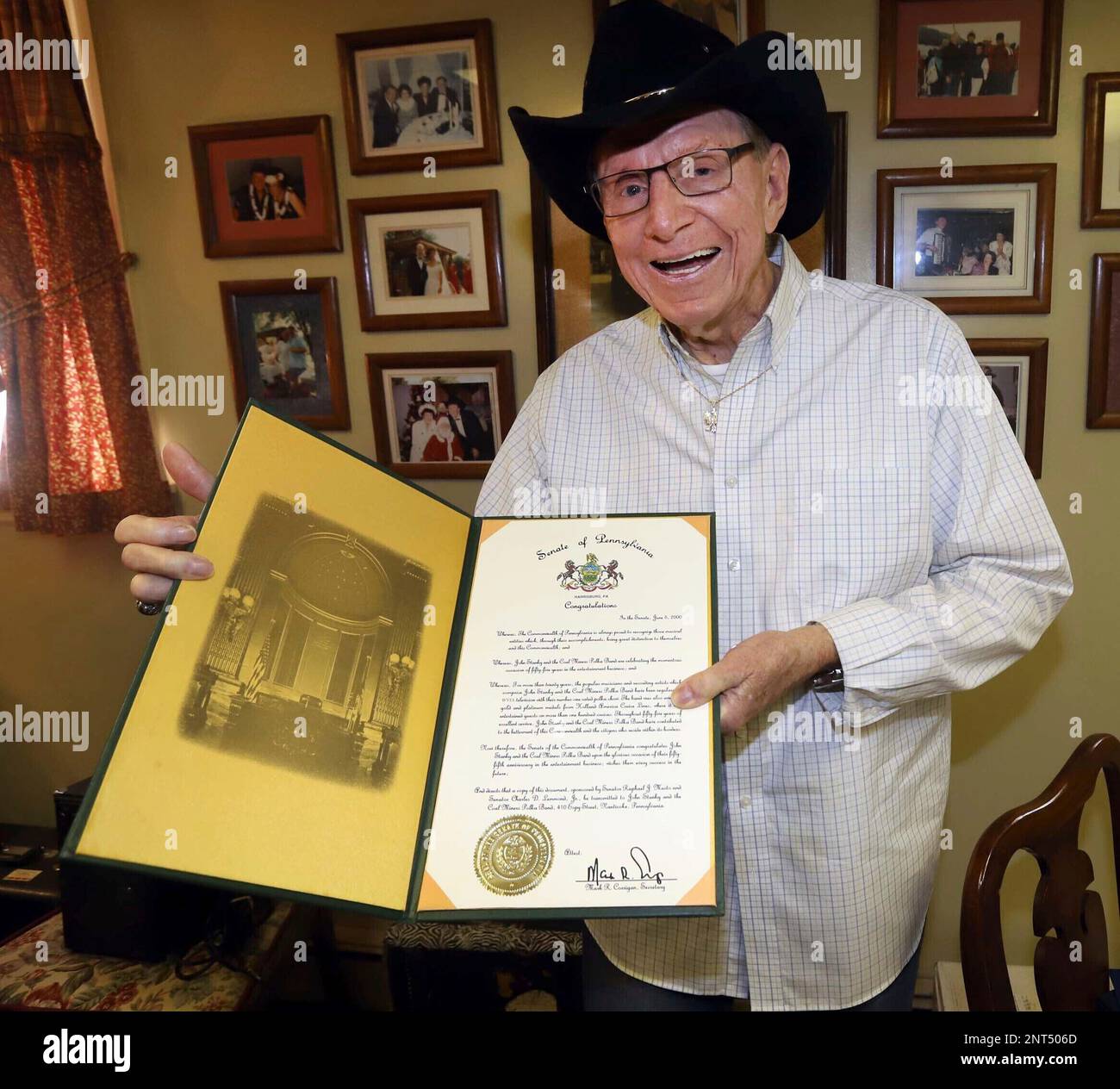 John Stanky Stankovic poses with one of the many citations and awards ...