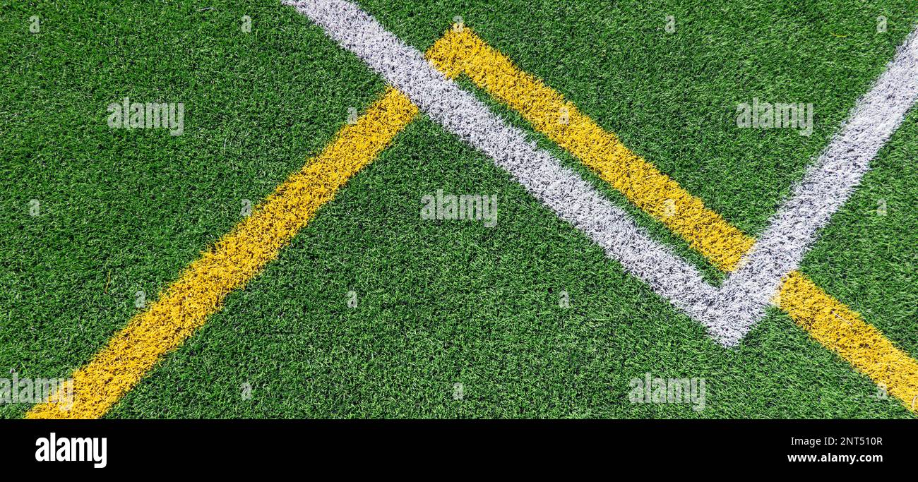 Green artificial grass turf soccer football field background with white ...
