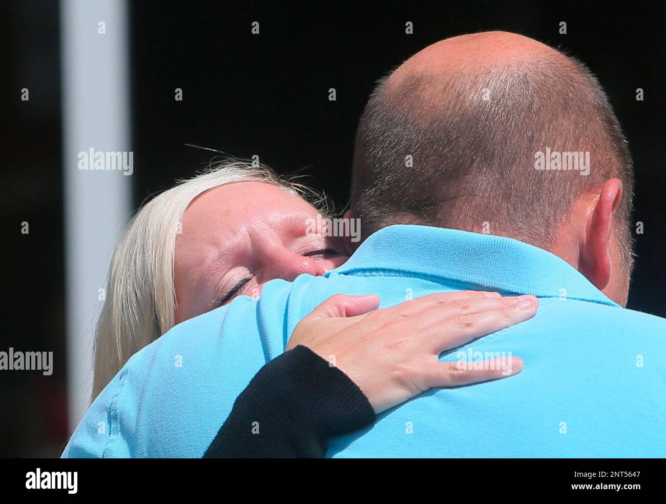 Krystal Conn hugs her husband on Monday, Aug. 12, 2019, outside the St ...