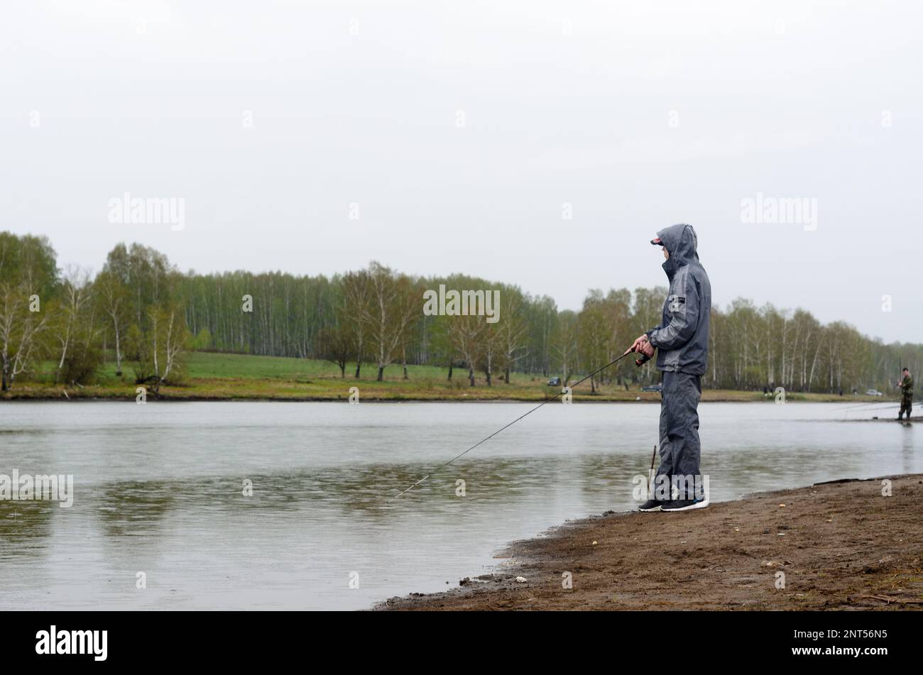 Russian modern male fisherman fishes on an ultralight spinning rod in ...