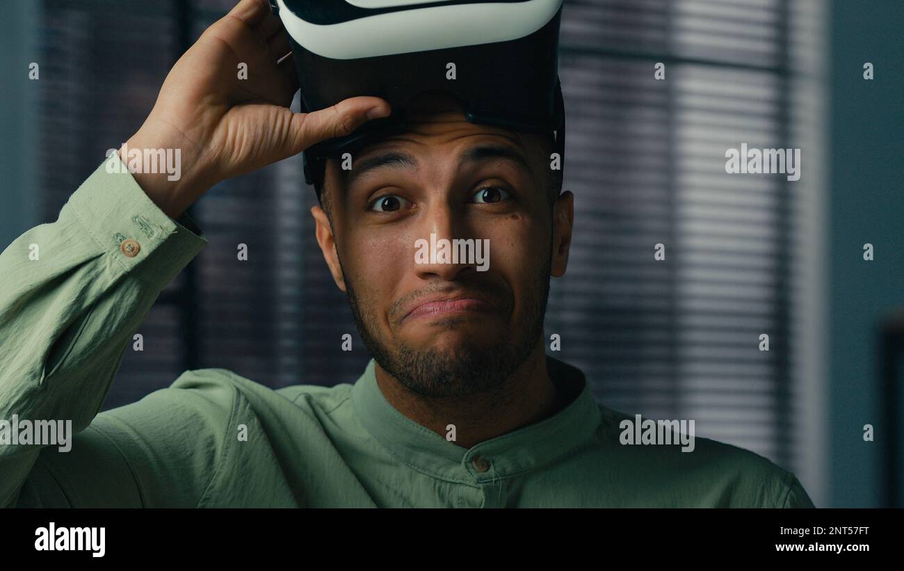 Surprised african american man take off VR glasses in 3D metaverse ...