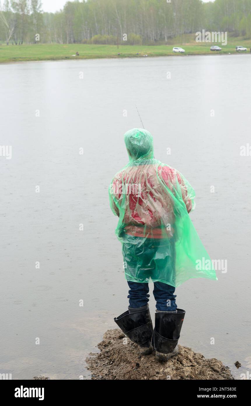 Russian modern male fisherman fishes on an ultralight spinning rod in ...