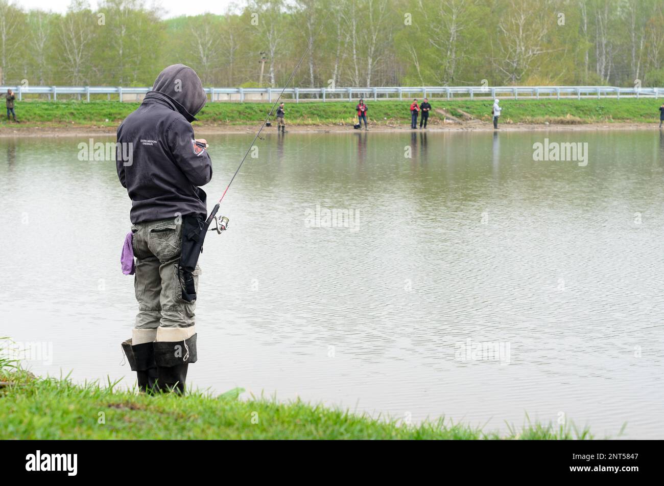 Russian modern male fisherman fishes on an ultralight spinning rod in ...