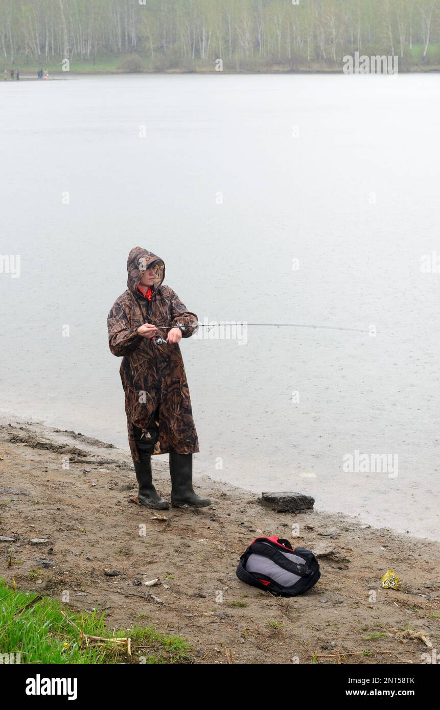 Russian modern male fisherman fishes on an ultralight spinning rod in ...