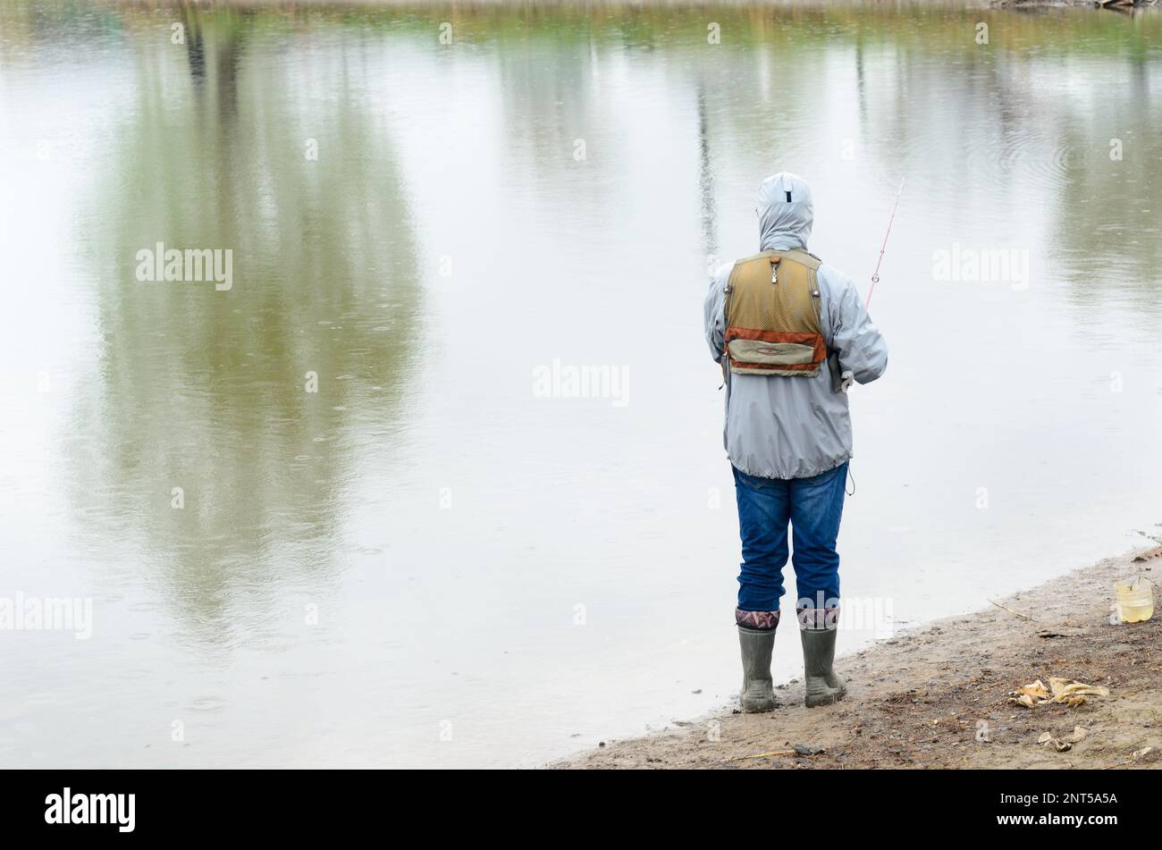 Russian modern male fisherman fishes on an ultralight spinning rod in ...