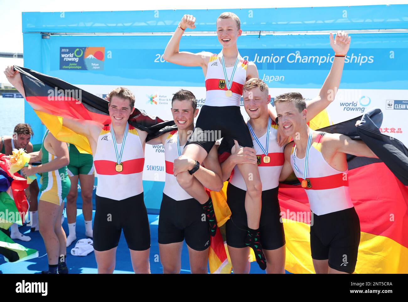 Germany team members celebrate on the podium after winning the (JM4 ...