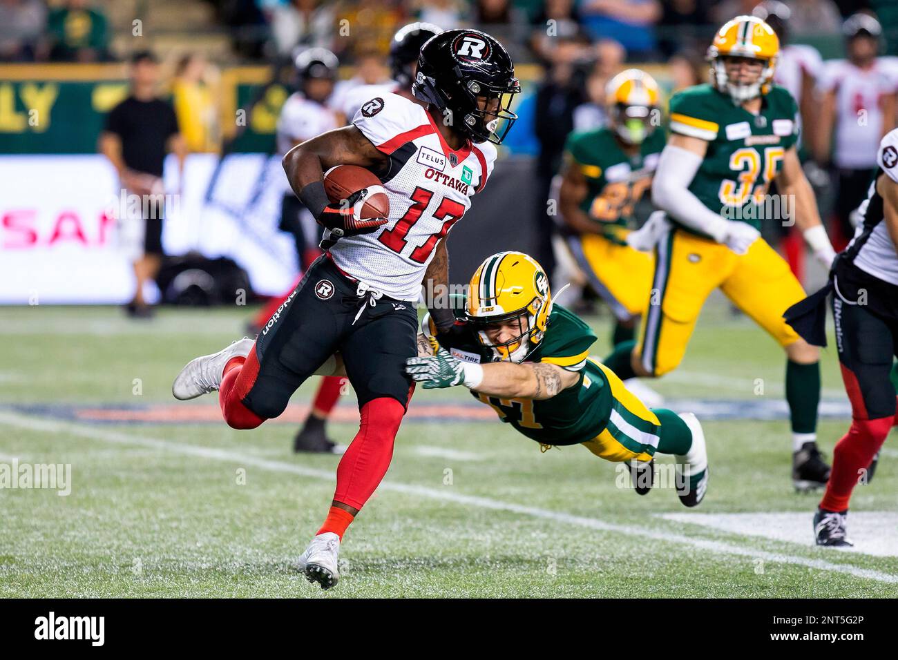 Ottawa Redblacks' DeVonte Dedmon (17) is tackled by Edmonton Eskimos ...