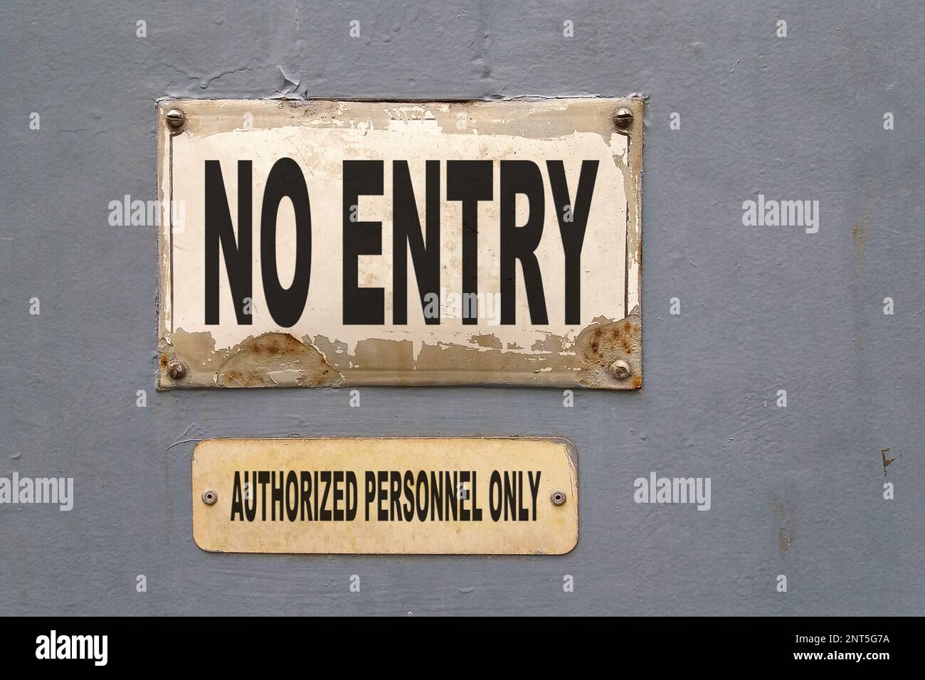 Two signs on a door with written "No entry" on the top one and ...