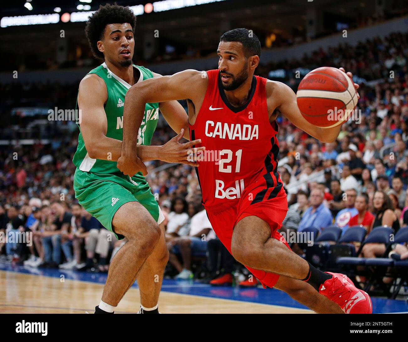 Canada's Thomas Schubb (21) works his way around Nigeria's Jordan Nwora ...