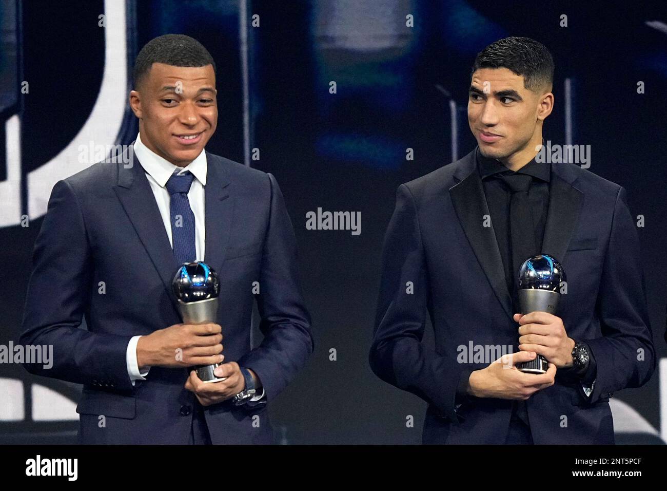 Kylian Mbappe, left, and Achraf Hakimi, pose with trophies Men's World 11 during the ceremony of ...