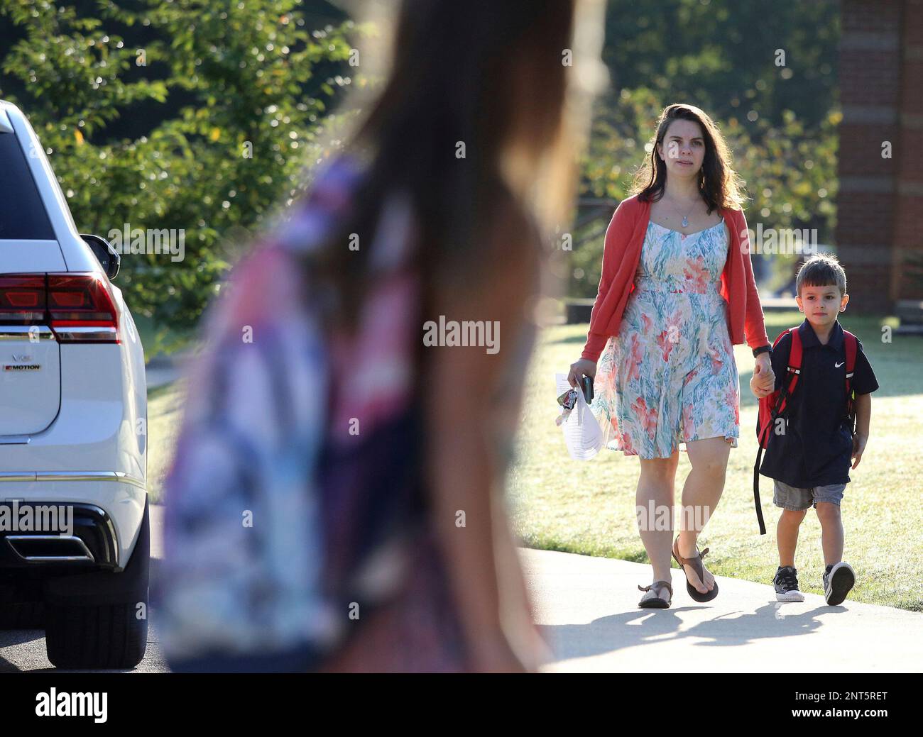 Emily Darras walks her son Henry Darras, a first grader, to school ...