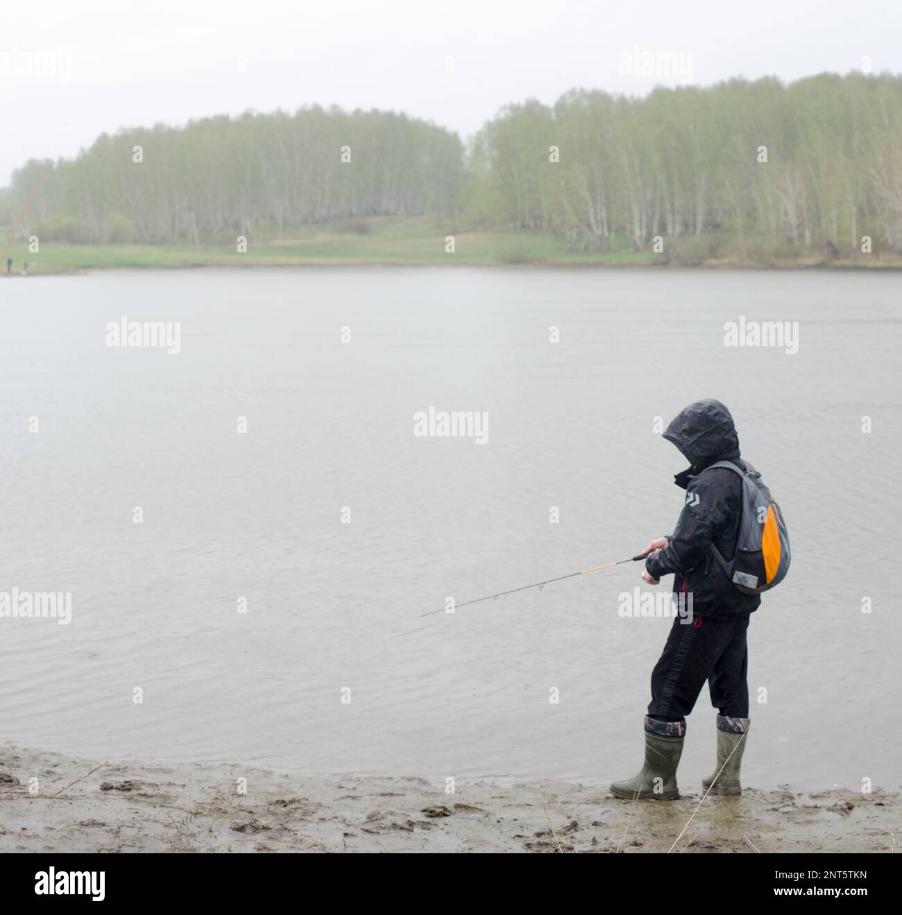 Russian modern male fisherman fishes on an ultralight spinning rod in ...