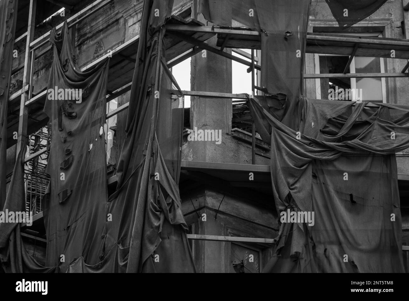 Low angle black and white of facade of modern building under ...
