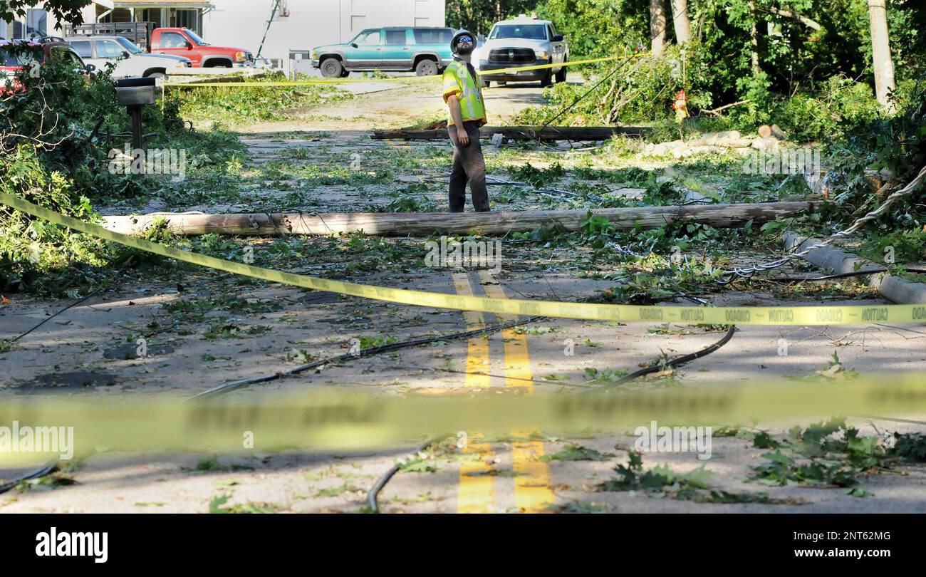 A National Grid worker surveys damage on Handy Street in Attleboro ...