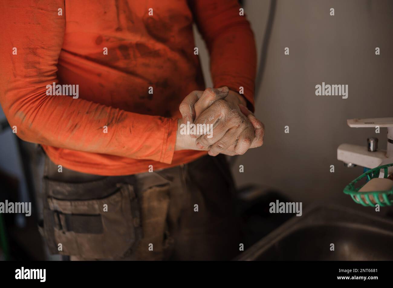 The mechanic washes his hands after car repair. Man washing his hands ...