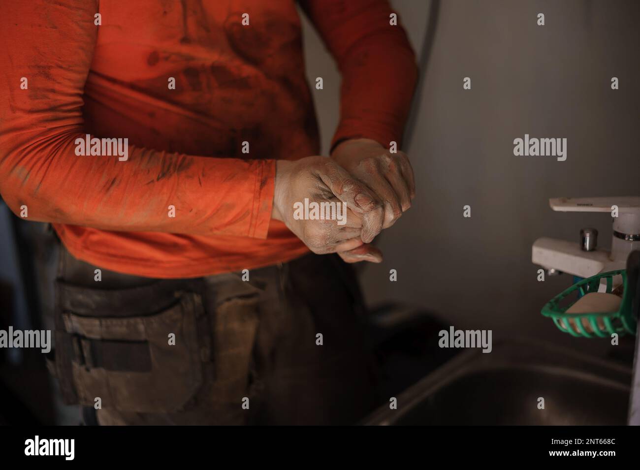 The mechanic washes his hands after car repair. Man washing his hands ...