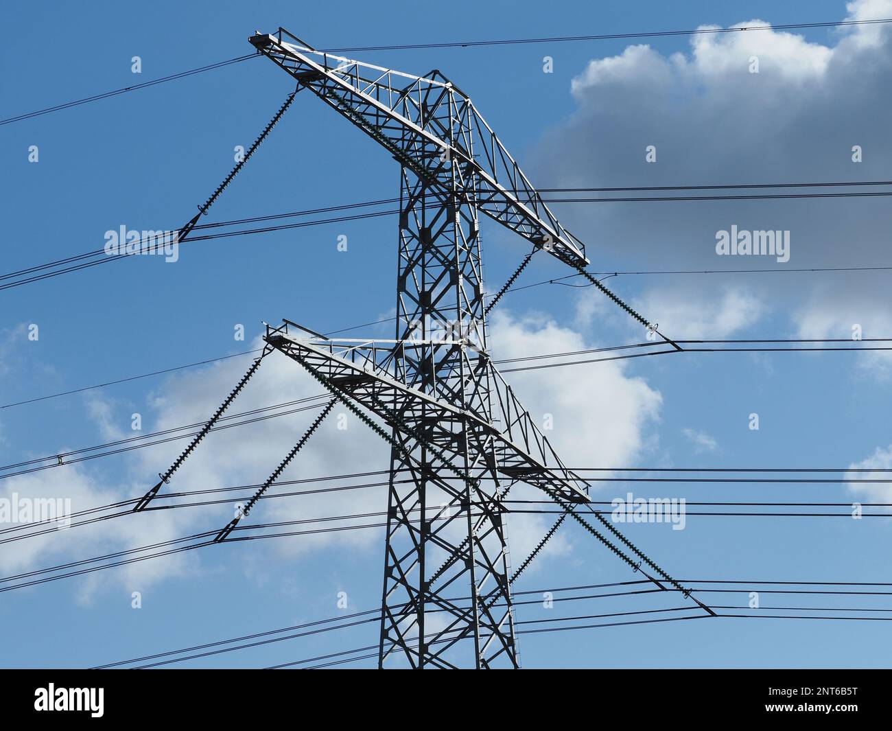 high voltage power electicity lines mast tower closeup in the port area ...