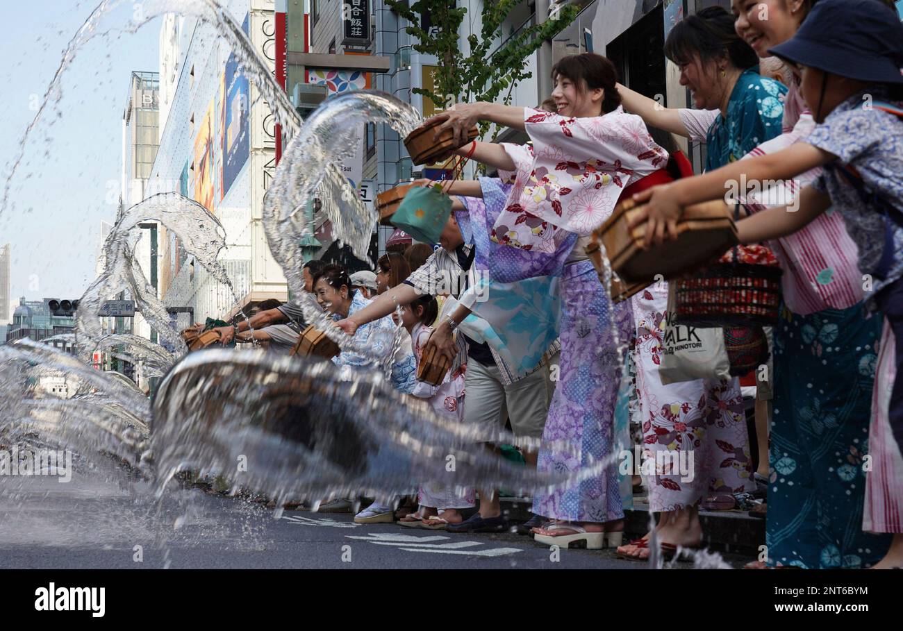 Participants wearing Yukata, Japanese cotton kimono, spray water in ...