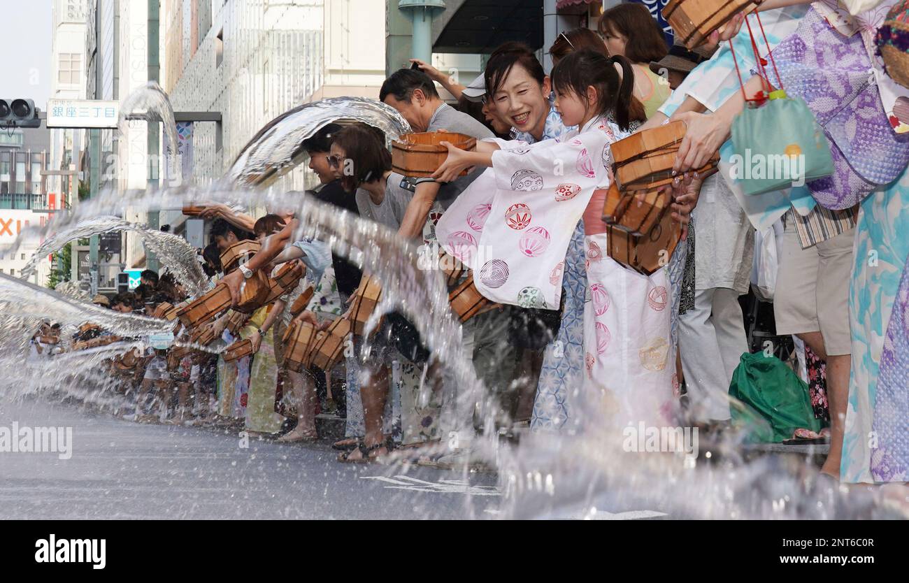 Participants wearing Yukata, Japanese cotton kimono, spray water in ...