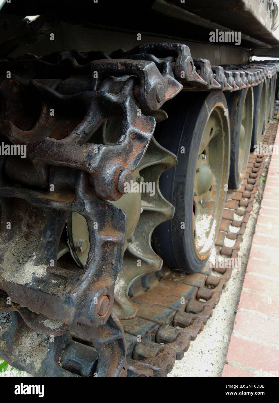 Wheels and suspension of rare tracked war machine with dirt and rust on ...